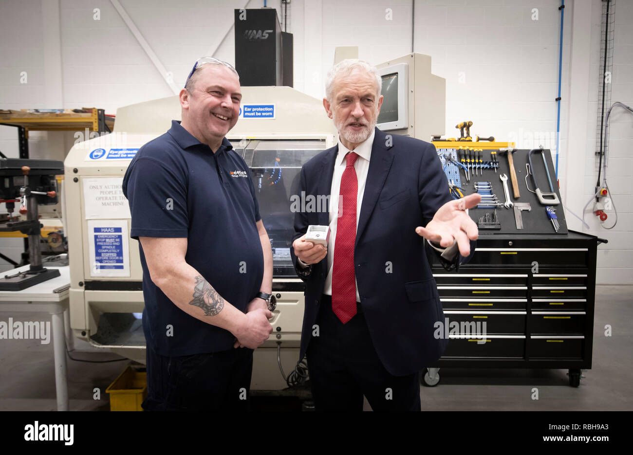 Labour leader Jeremy Corbyn (right) talks to staff member George Mooney ...