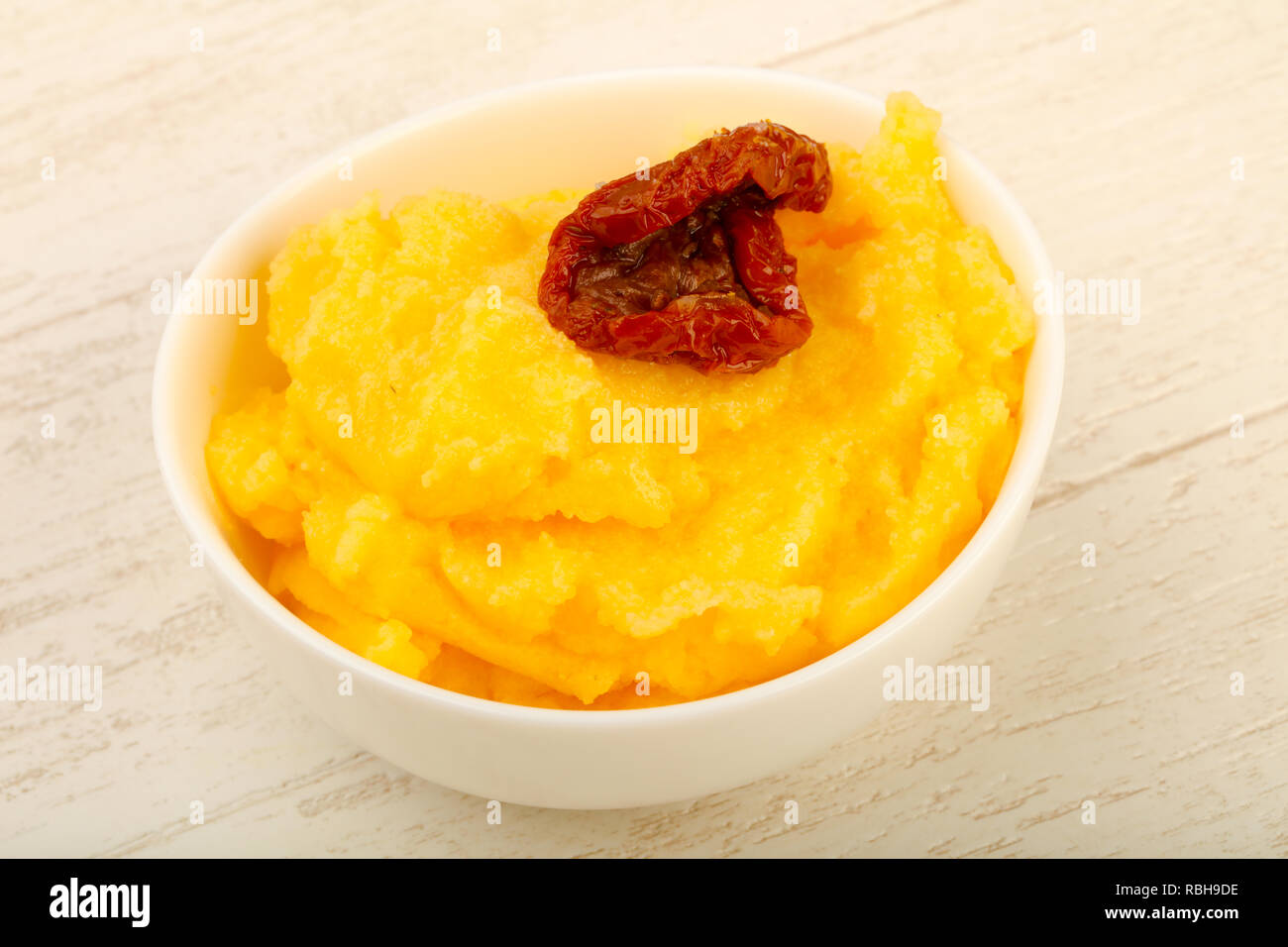 Polenta with dry tomato Stock Photo - Alamy