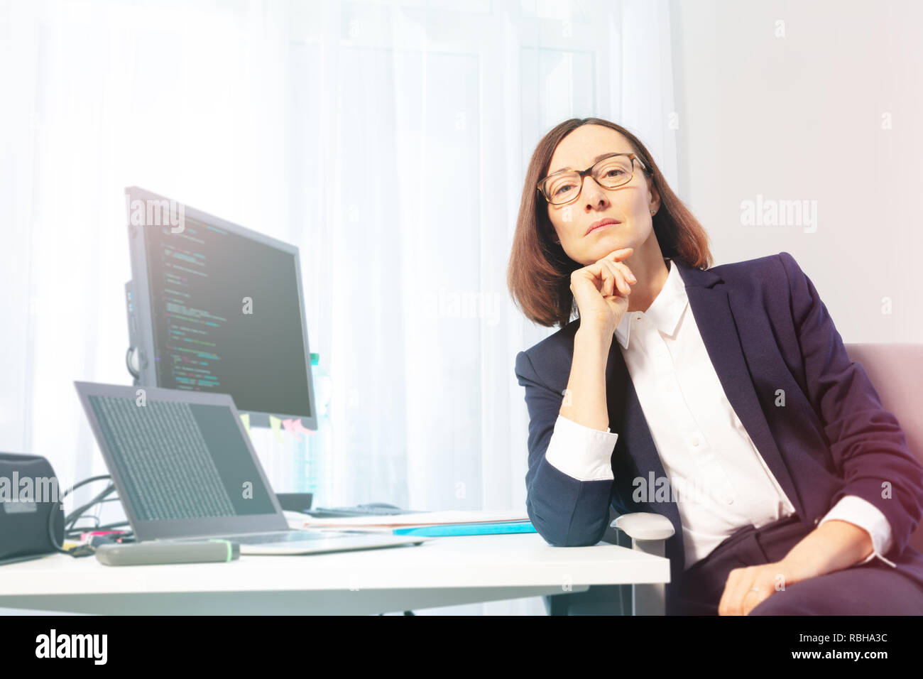 Serious business woman working in the office Stock Photo - Alamy