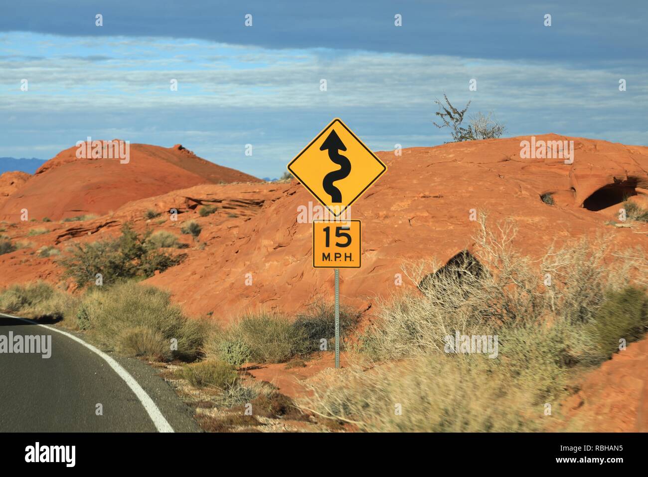 Highway sign along the curved desert road Stock Photo - Alamy