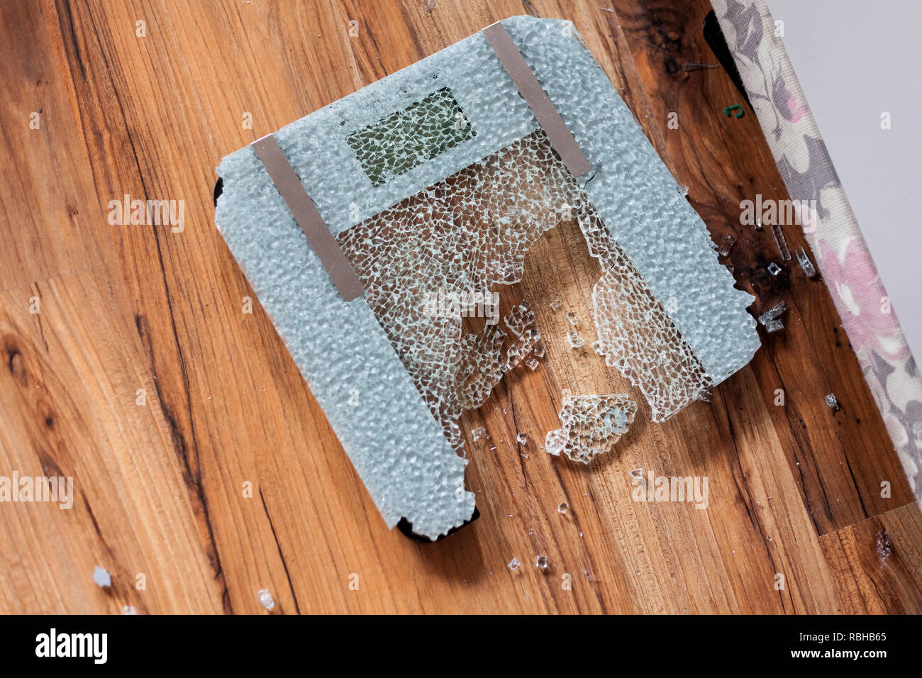 Broken digital human scale on the floor. Broken glassy digital scale ...