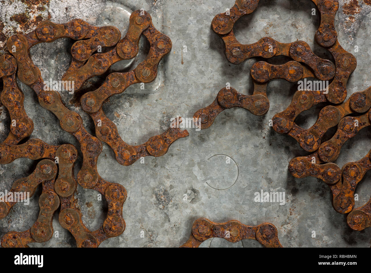 Weakest link in a strong steel rusty roller chain is broken snapped ...