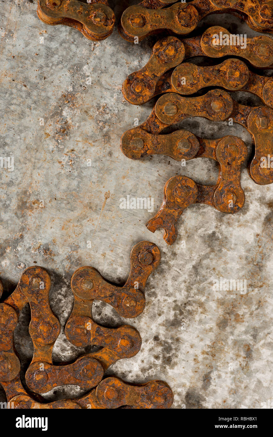Weakest link in a strong steel rusty roller chain is broken snapped ...