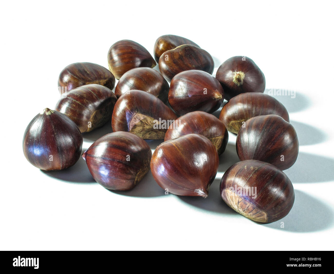 group of fresh chestnuts on a white background Stock Photo - Alamy
