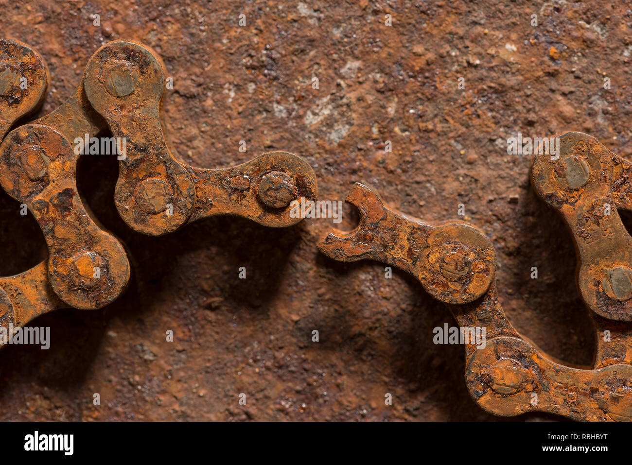 Weakest link in a strong steel rusty roller chain is broken snapped ...
