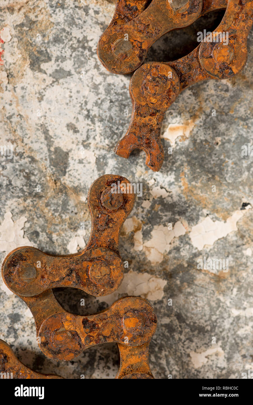 Weakest link in a strong steel rusty roller chain is broken snapped ...