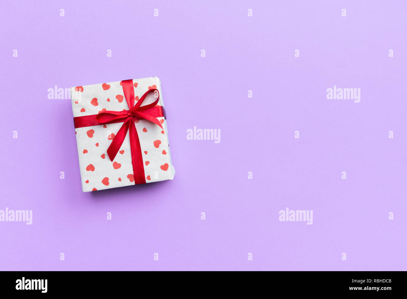 Valentine or other holiday handmade present in paper with red hearts ...