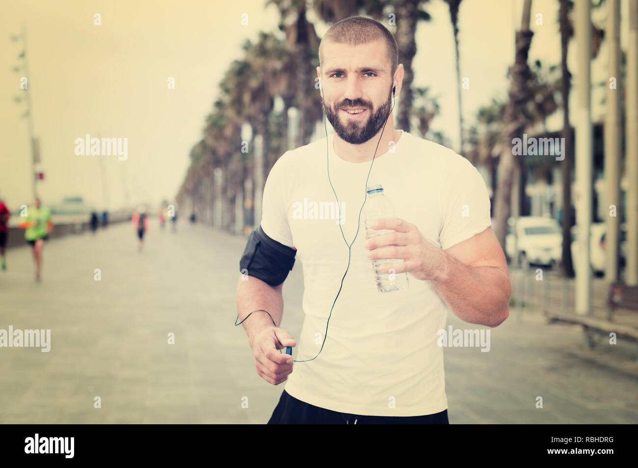 Athletic male stopped to rest while running Stock Photo - Alamy
