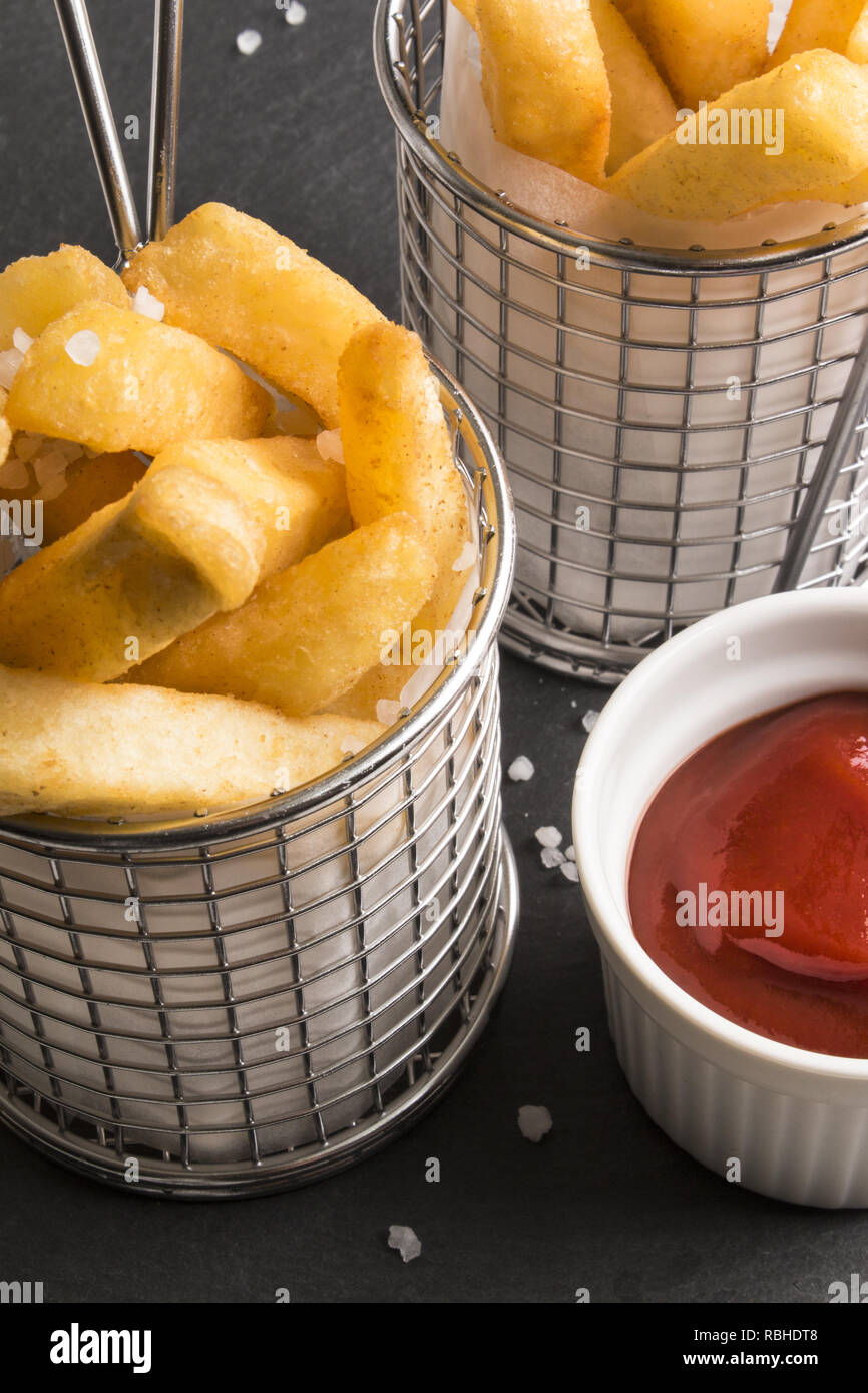 french fries in a serving basket, served with spicey home made ketchup ...