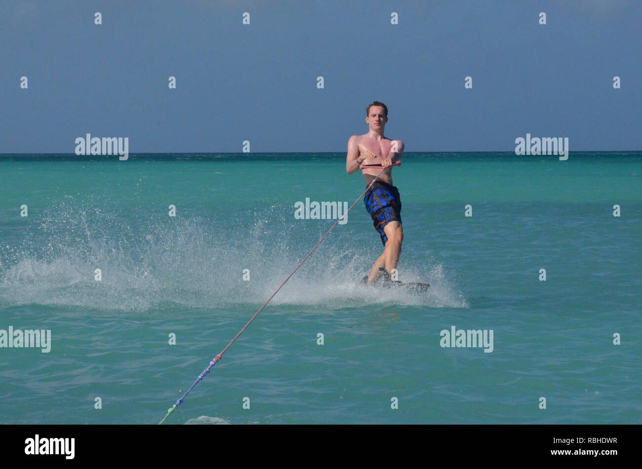 Guy wakeboarding in Aruba off of Palm Beach Stock Photo - Alamy