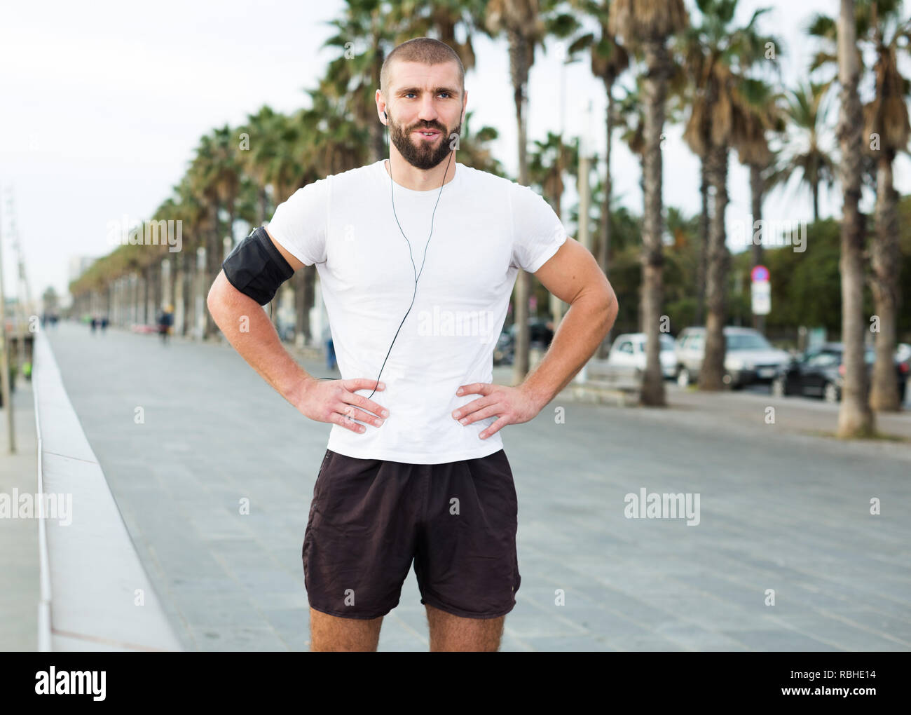 Athletic male stopped to rest while running Stock Photo - Alamy