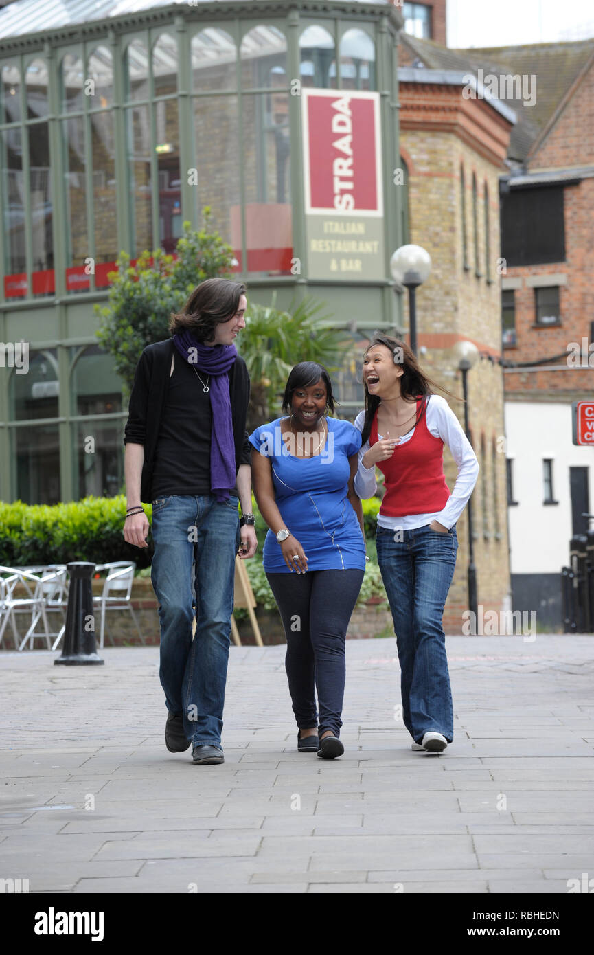 Teenage college students relax around Kingston Upon Thames, Surrey, UK ...