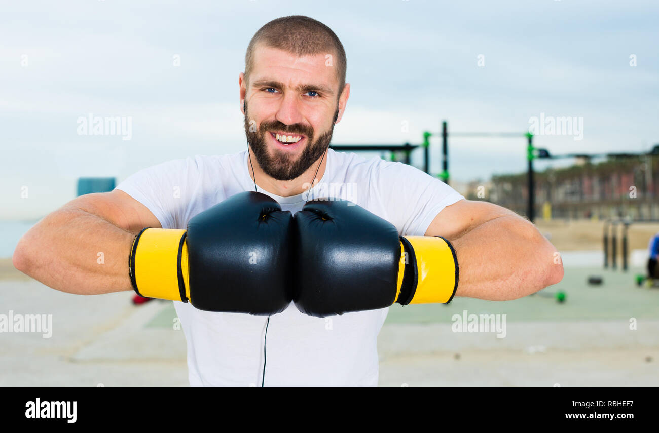 Man in boxing gloves is practicing on an outdoor sports field Stock ...