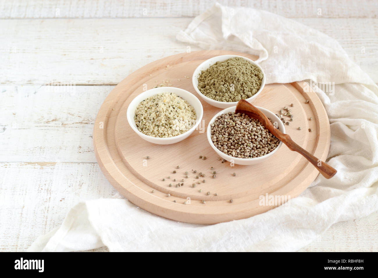 Organic hemp whole seeds, hulled seeds and protein powder in bowls on a ...