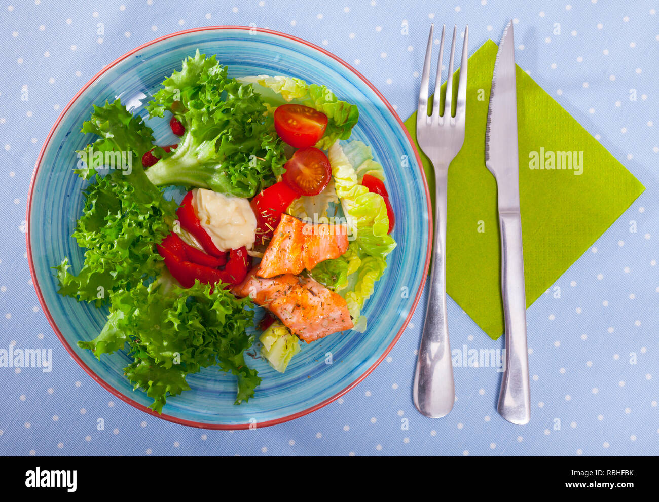 Grilled fillet of trout fish served with fresh vegetables and greens ...