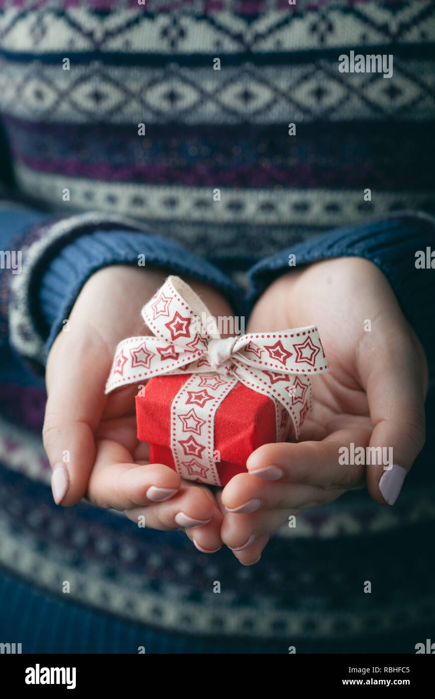 Close up shot of female hands holding a small gift Stock Photo - Alamy