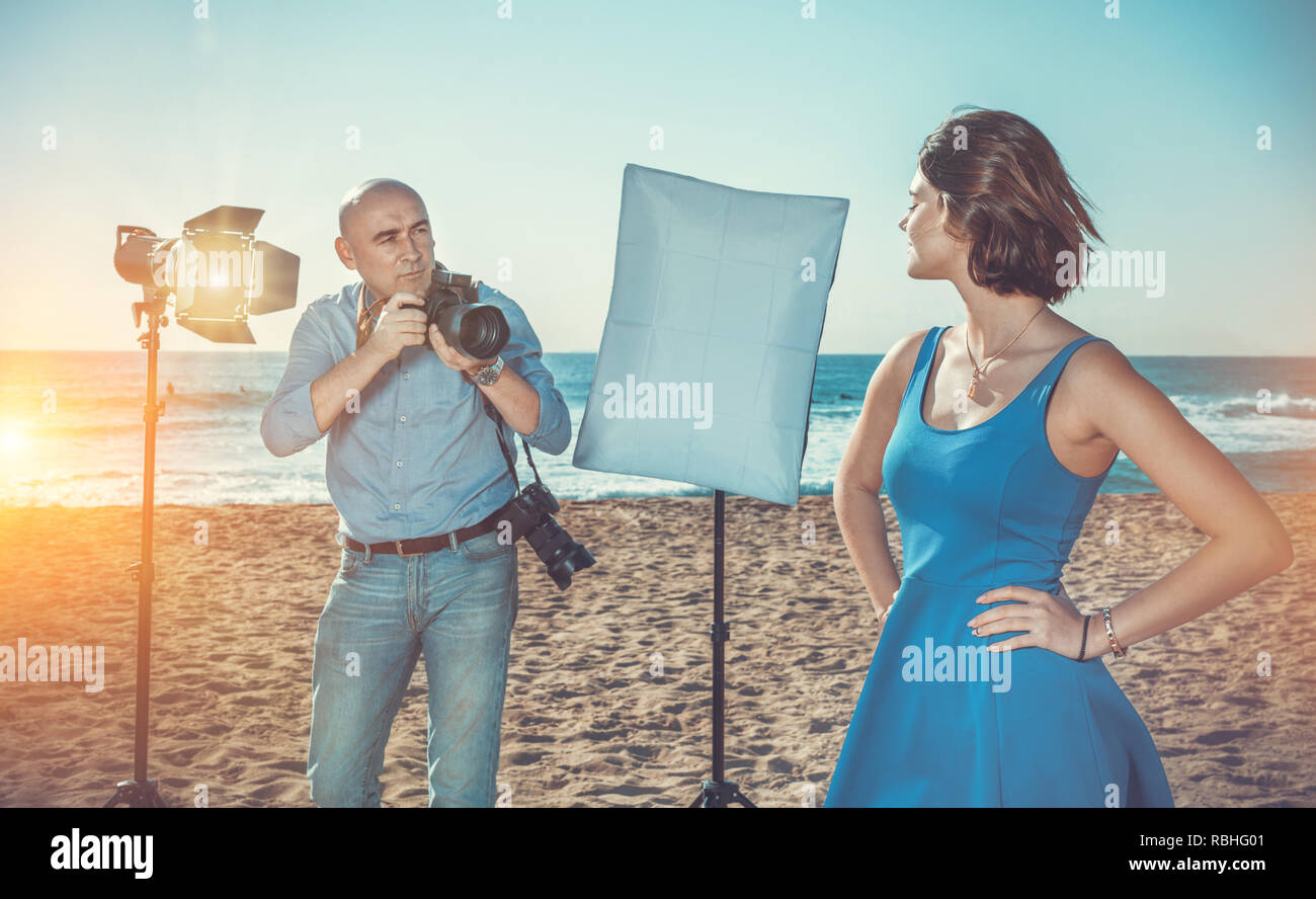 Photographer using professional camera and lighting equipment for ...