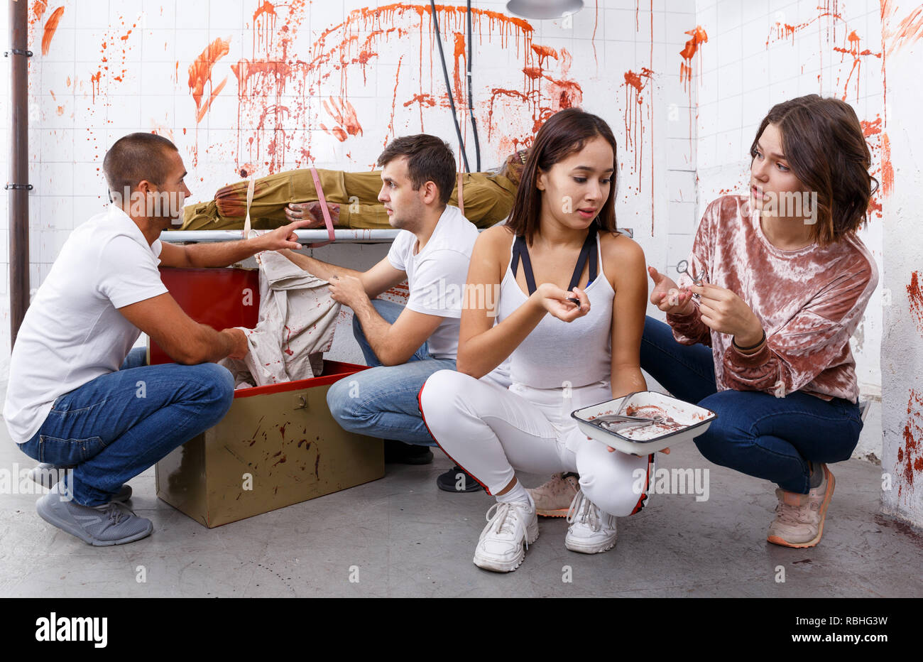 Group of young adults trying to get out of escape room stylized as ...