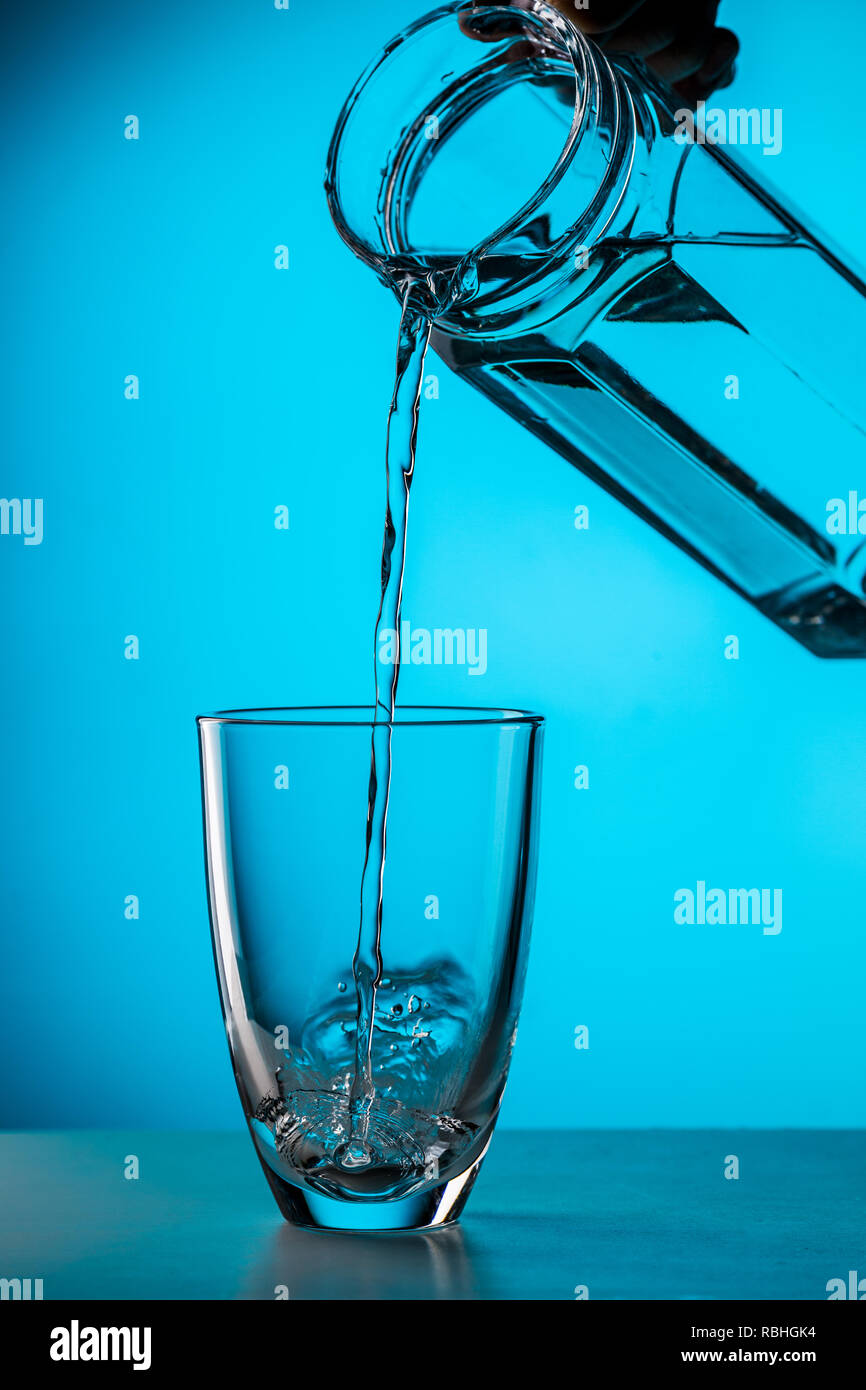 Hand pouring water from glass hi-res stock photography and images - Alamy