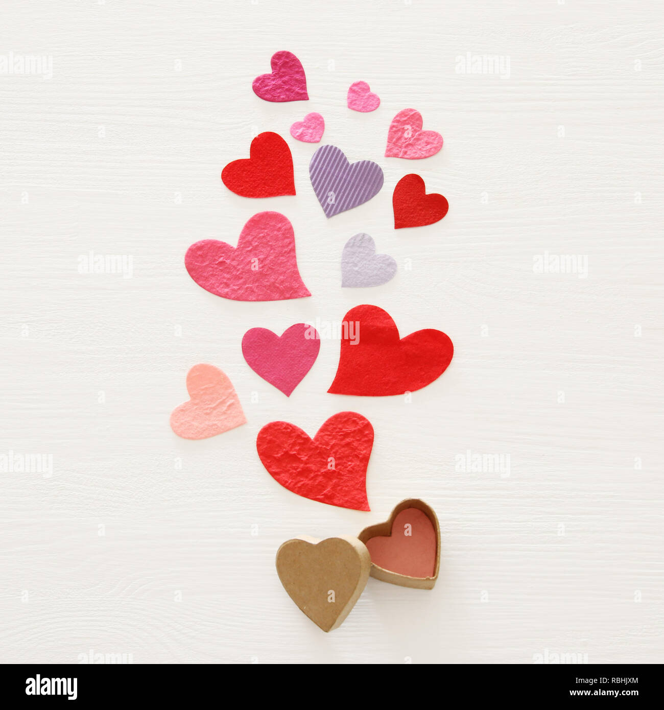 Valentine's day concept. Paper hearts over wooden white background ...
