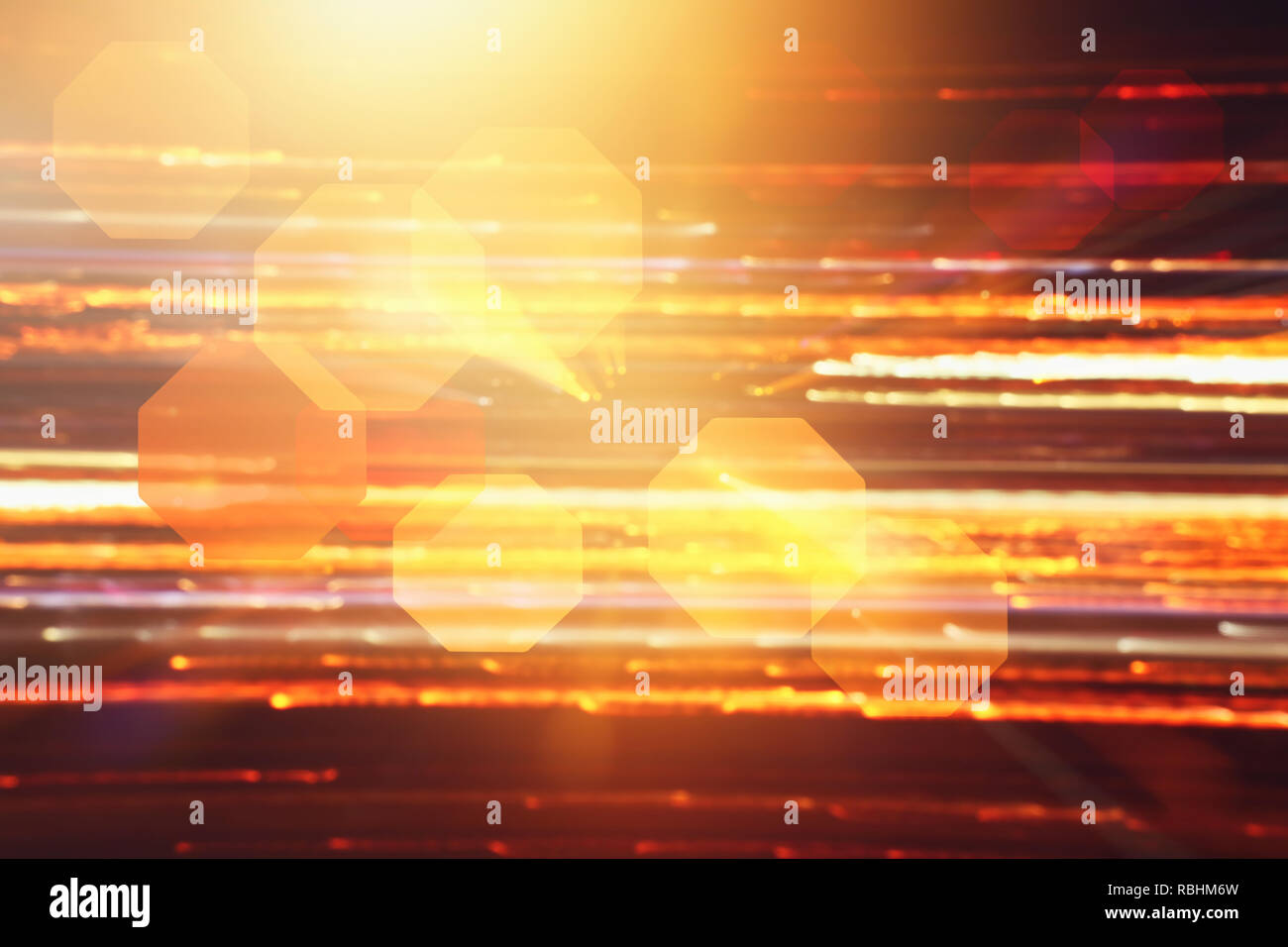 abstract background with bokeh defocused lights golden color and bright lines and lens flare ...