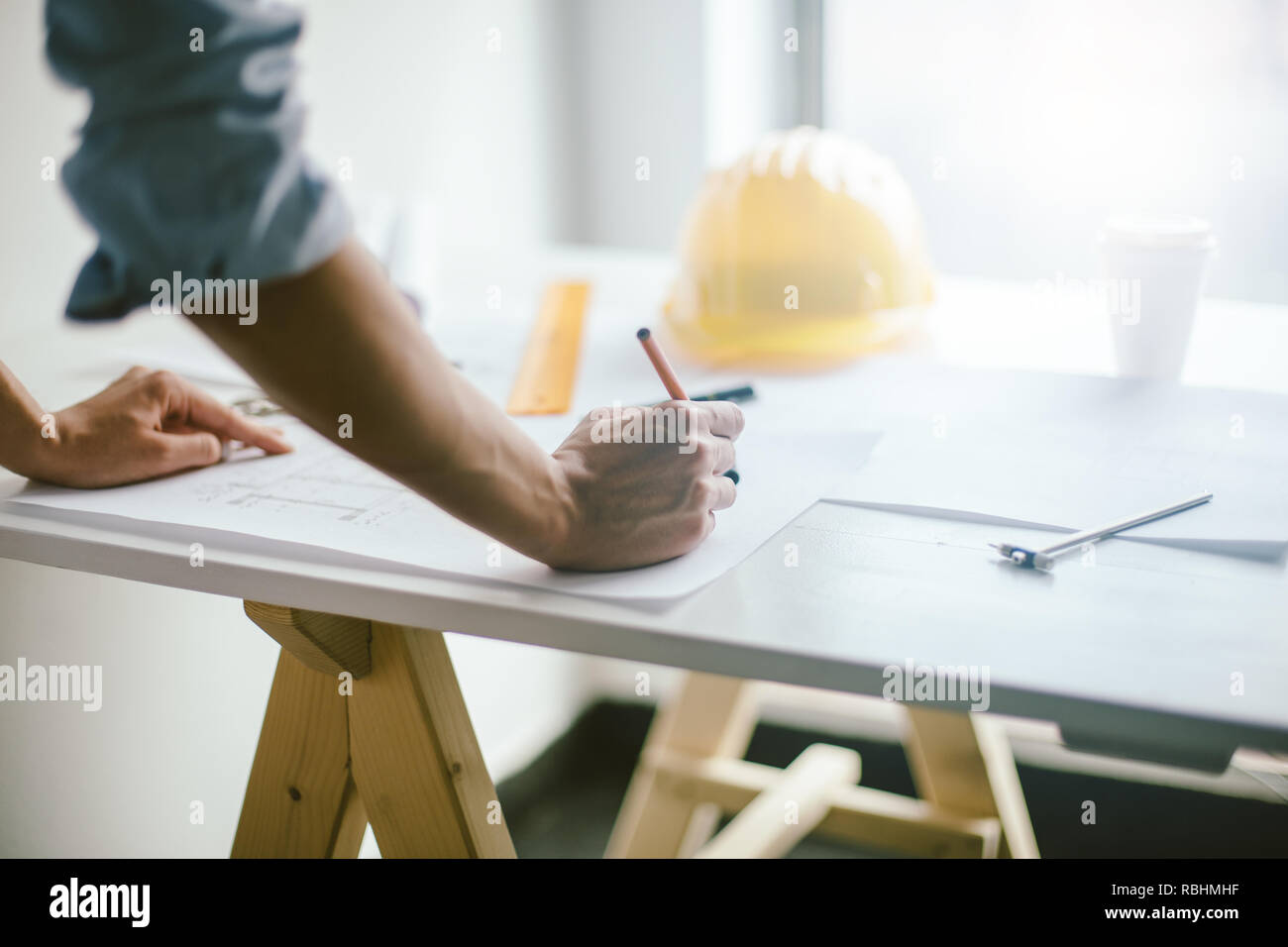 Construction engineering. Close up of architect hands working on table ...