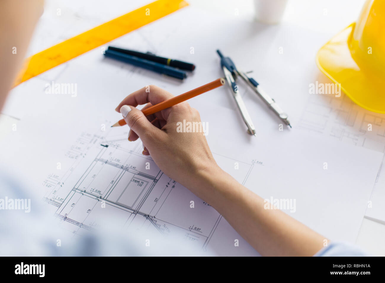 Architect drawing blueprints. Close up of construction engineer working ...