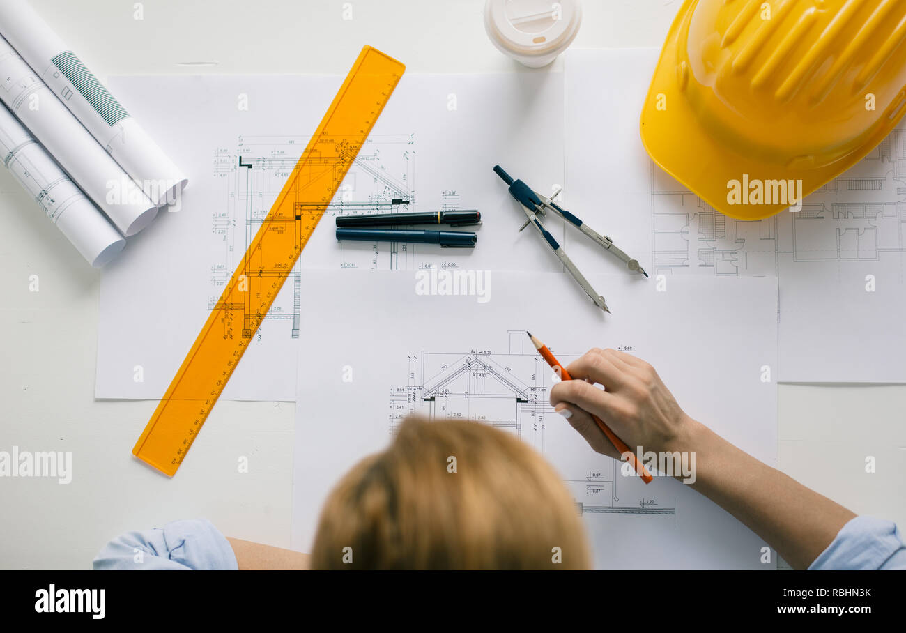 High angle view of architect drawing blueprints. Architectural ...