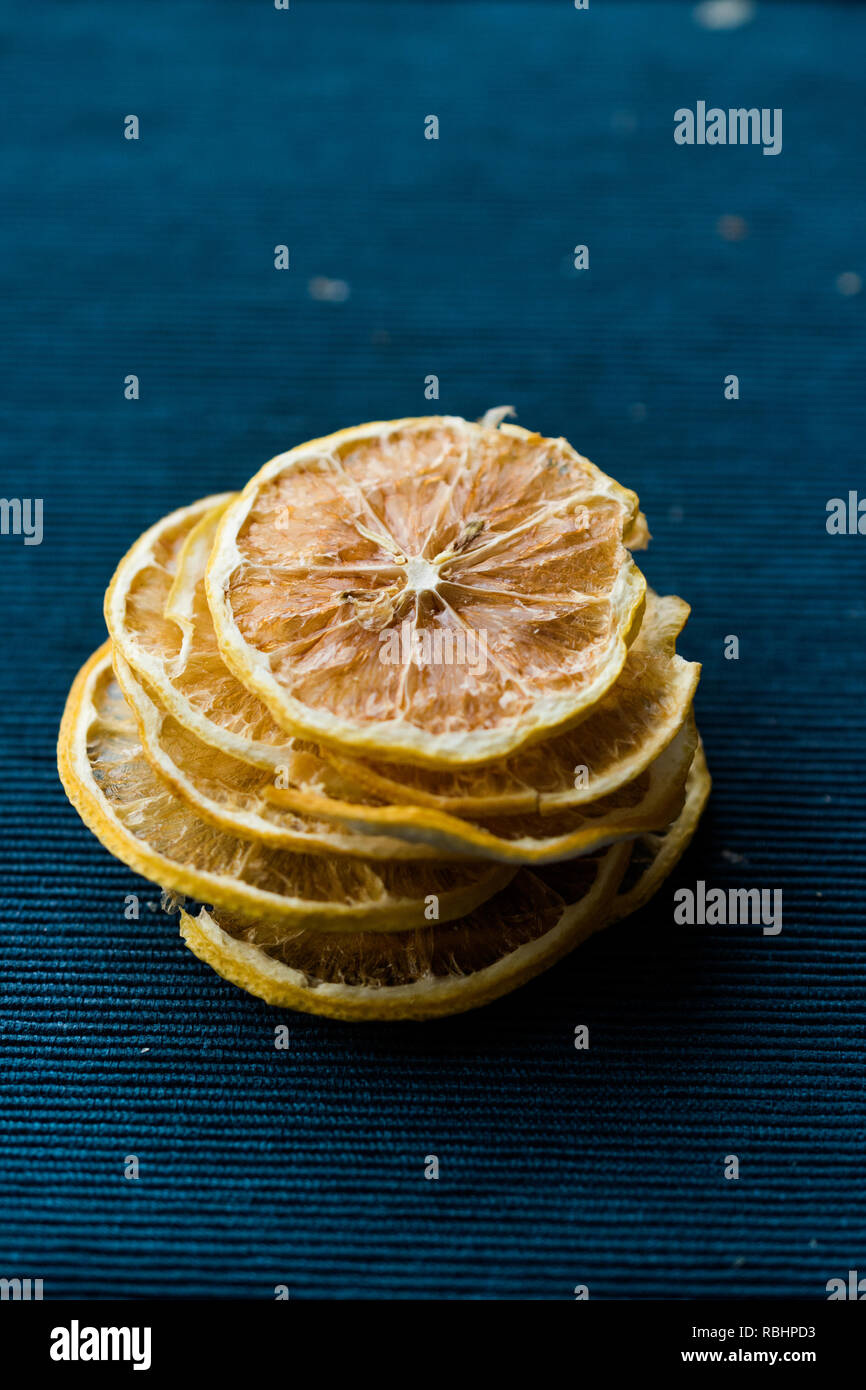 Stack of Dried Lemon Slices on Blue Surface / Dry and Sliced. Organic ...