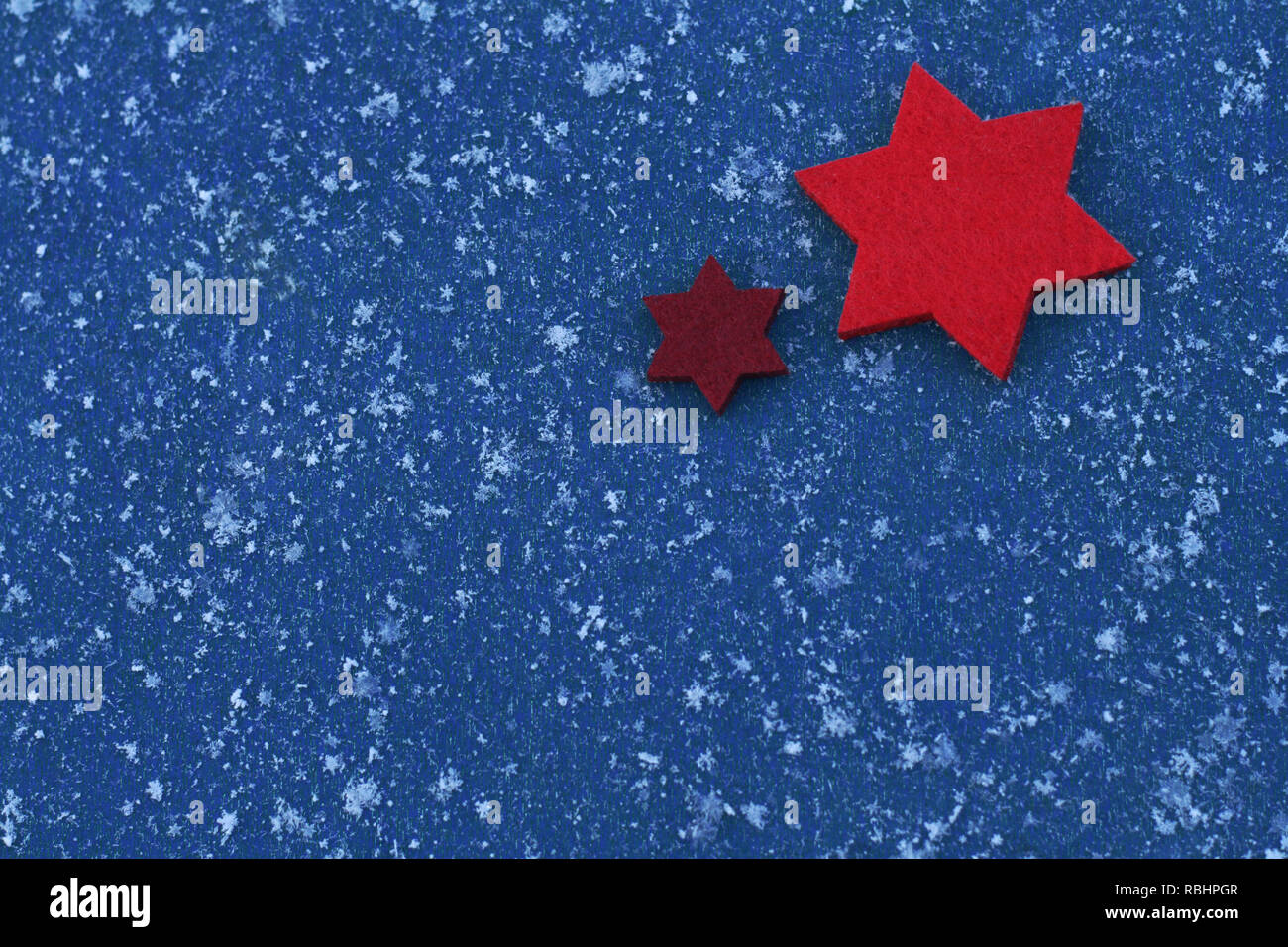 red christmas stars on blue background with snowflakes Stock Photo - Alamy