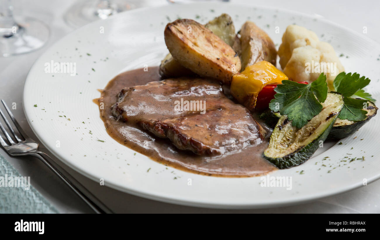 Delicious and juicy roasted meat, prepared in a fancy restaurant by a ...