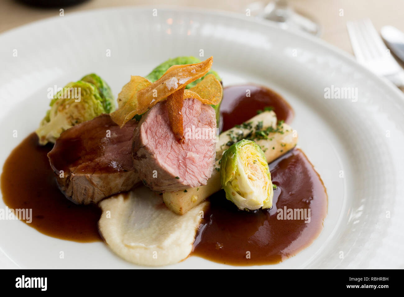 Delicious and juicy roasted meat, prepared in a fancy restaurant by a ...