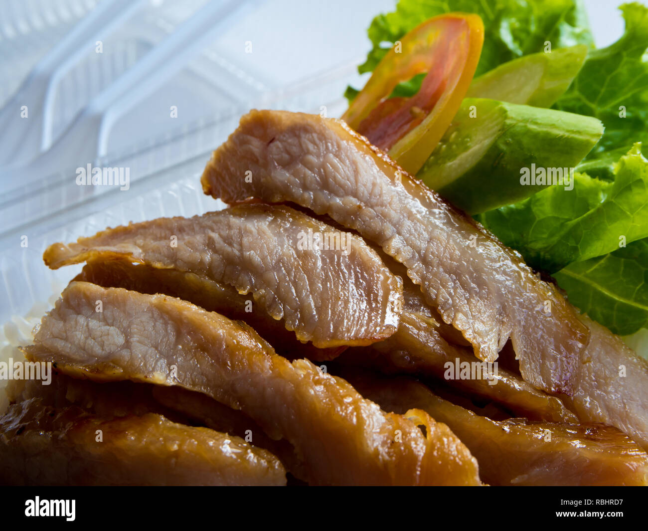 Roasted pork and rice in a transparent plastic box packaging Stock ...