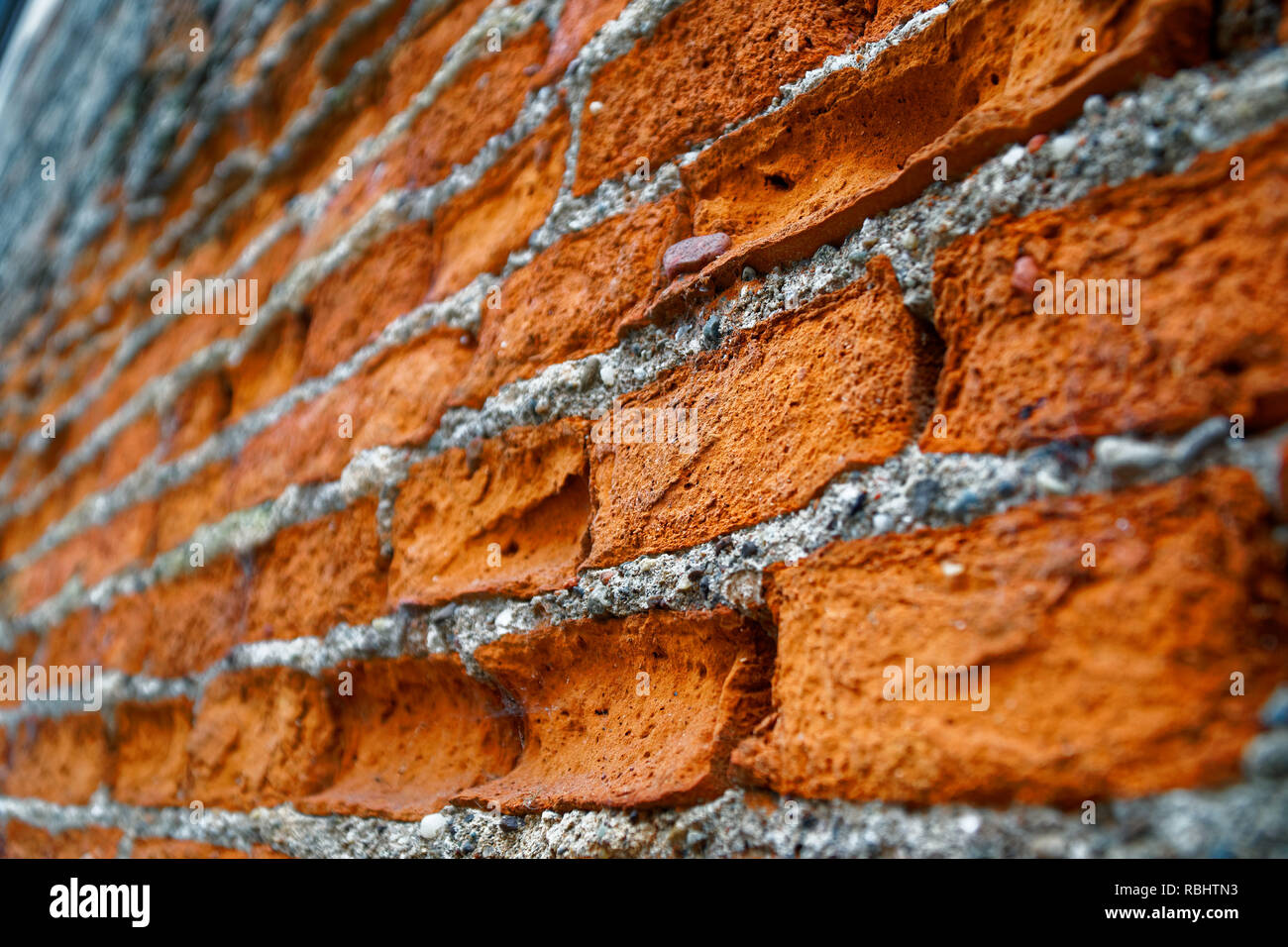 Worn Brick wall with different sized red battered blocks Stock Photo ...