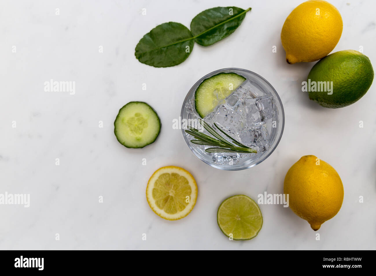 Gin tonic cocktail drink glass with ice cucumber lime lemon white ...