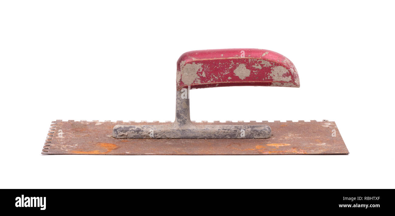 Rusty old notched trowel isolated on white Stock Photo - Alamy