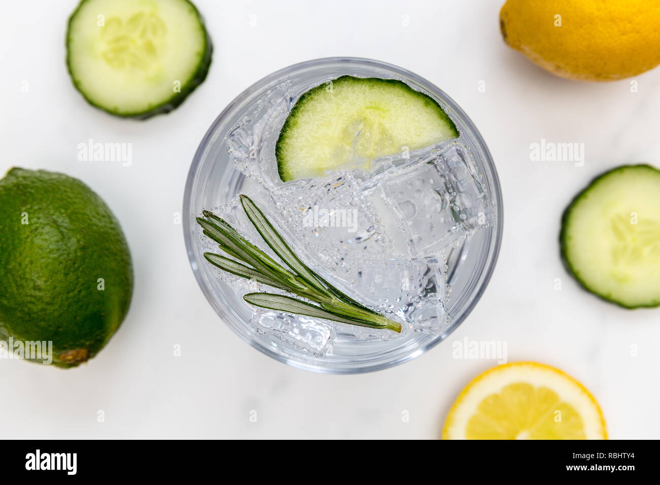 Gin tonic cocktail drink glass with ice cucumber lime lemon white ...