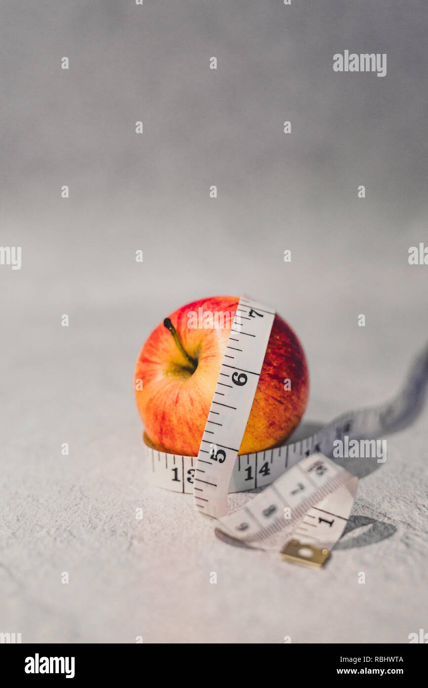 healthy diet concept, red apple with measuring tape around it Stock ...