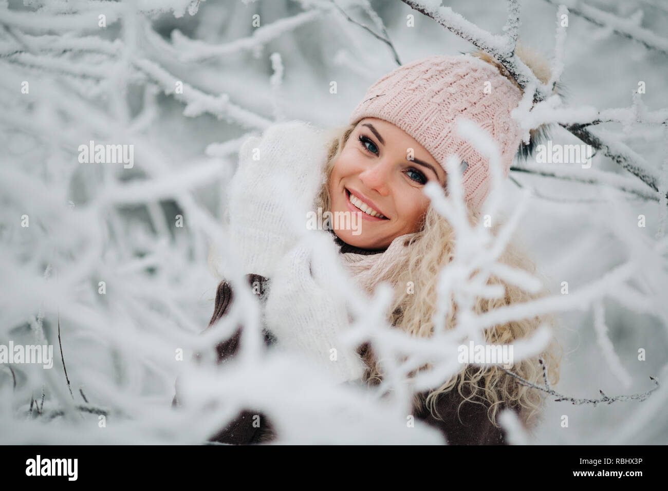 Photo of blonde woman on walk in winter forest Stock Photo - Alamy