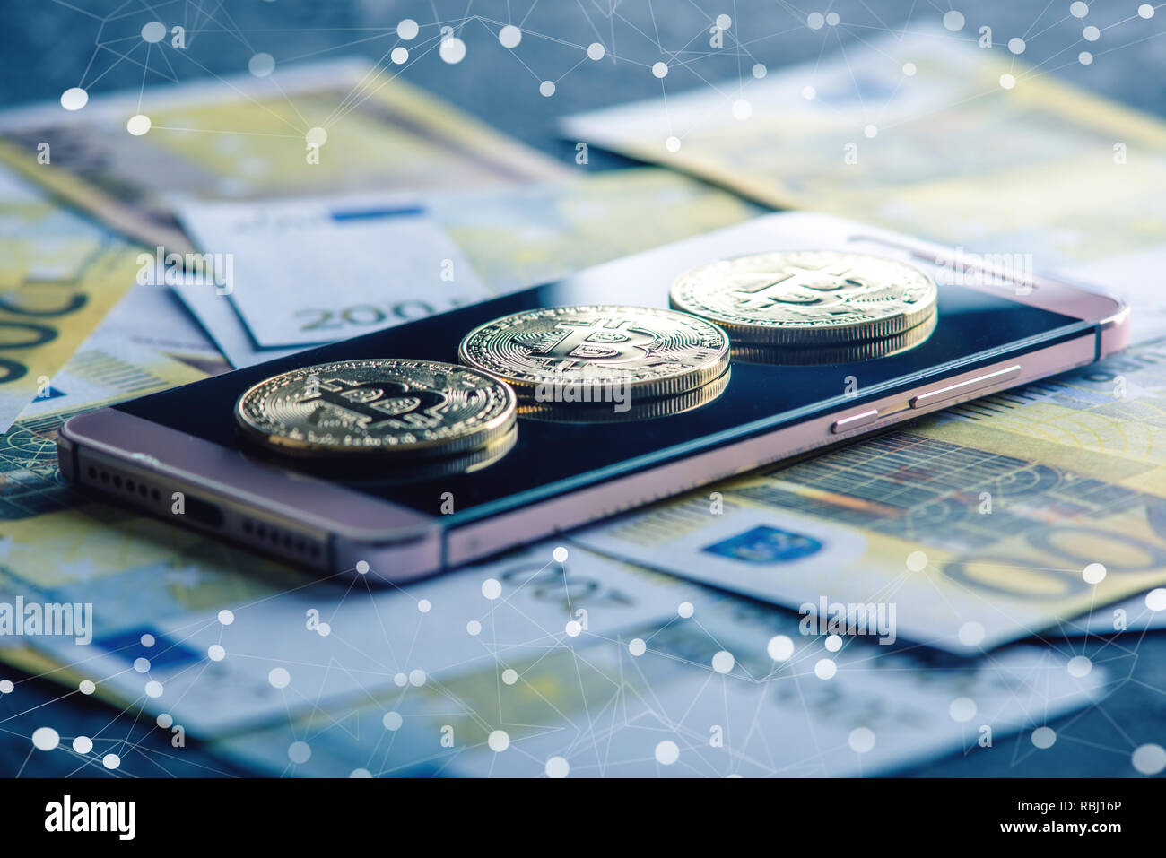 Bitcoin coin on the phone screen on the background of the Euro ...