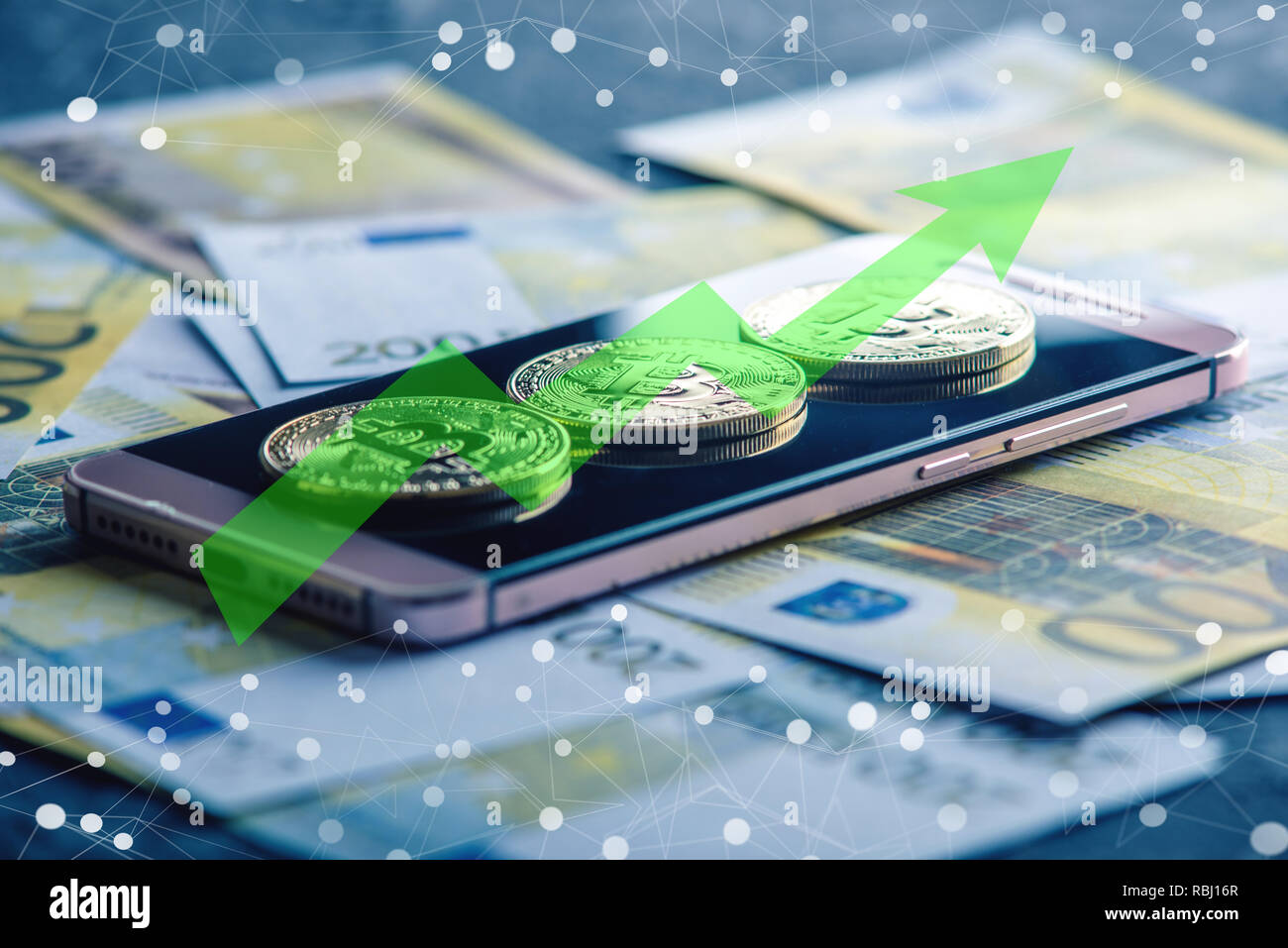 Physical bitcoin coin on the phone screen on the background of the Euro ...