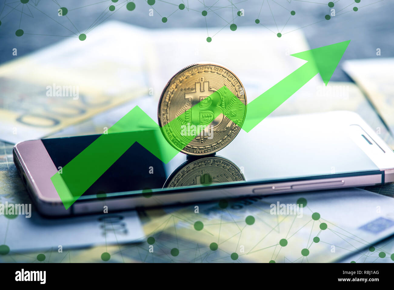 Physical bitcoin coin on the phone screen on the background of the Euro ...