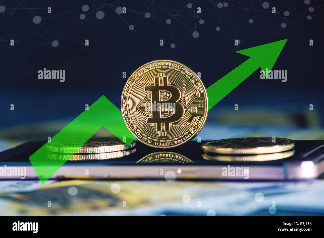 Physical bitcoin coin on the phone screen on the background of the Euro ...