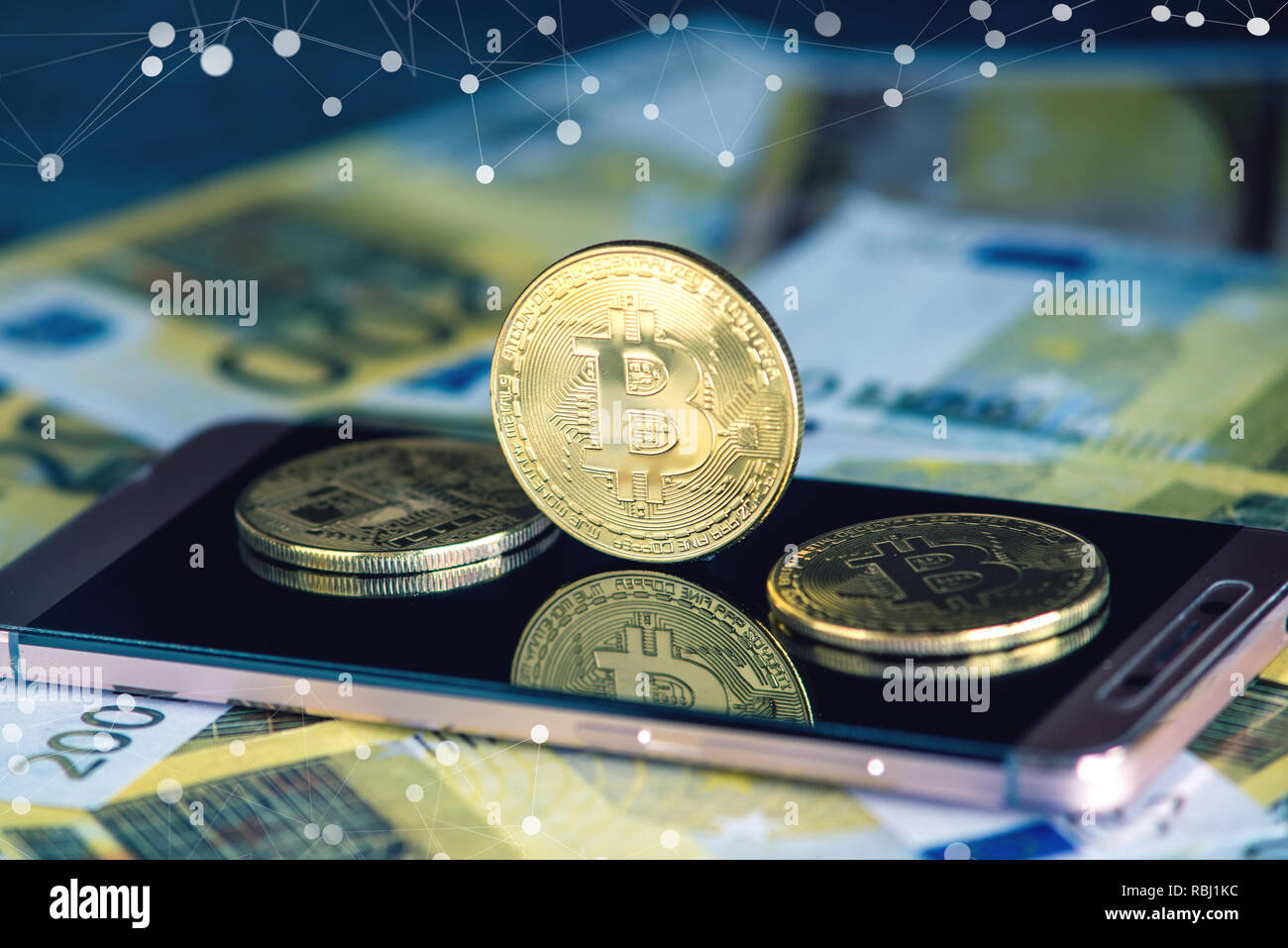 Bitcoin coin on the phone screen on the background of the Euro ...