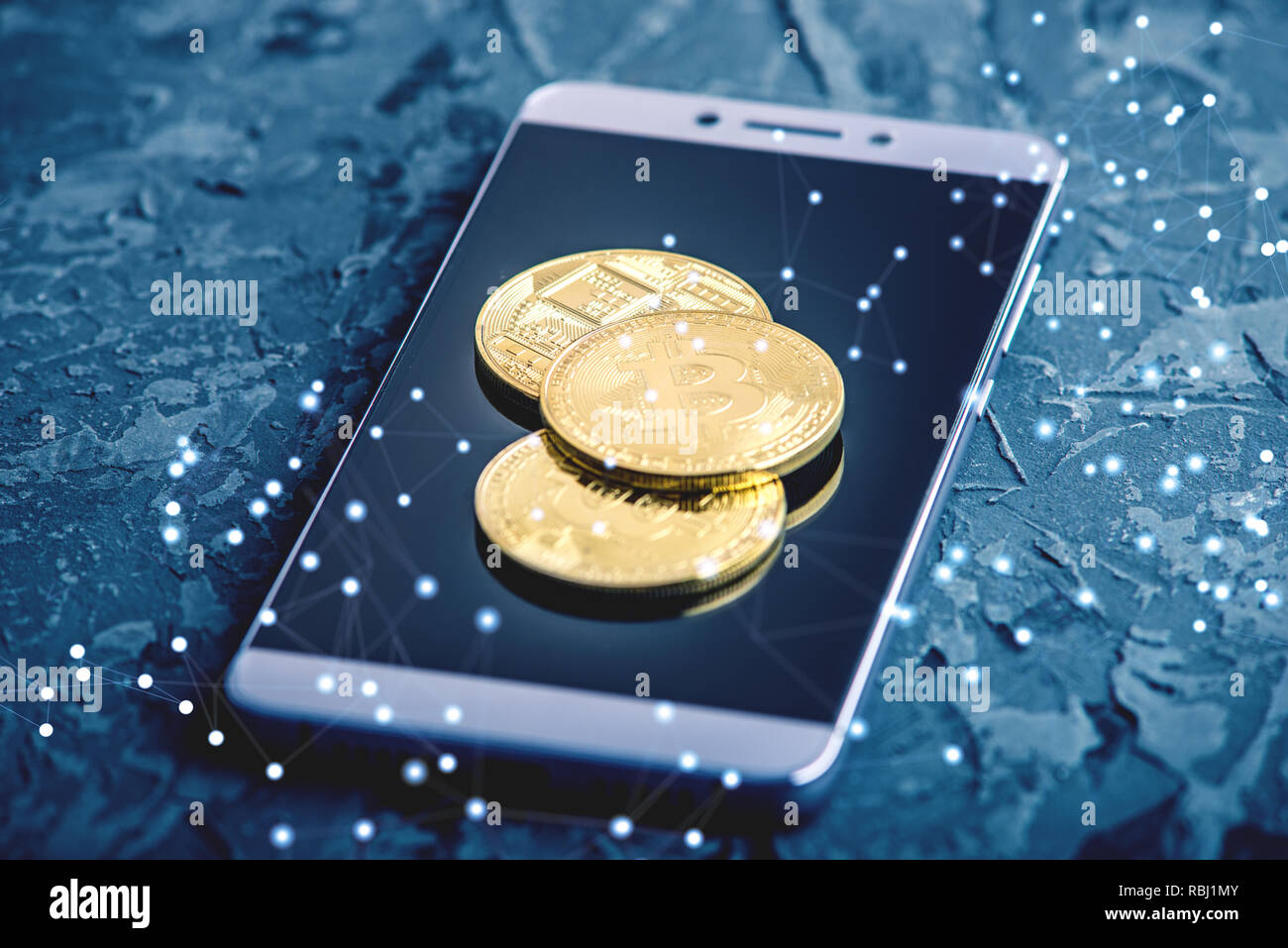 Physical bitcoin coin on the phone screen. The concept of ...