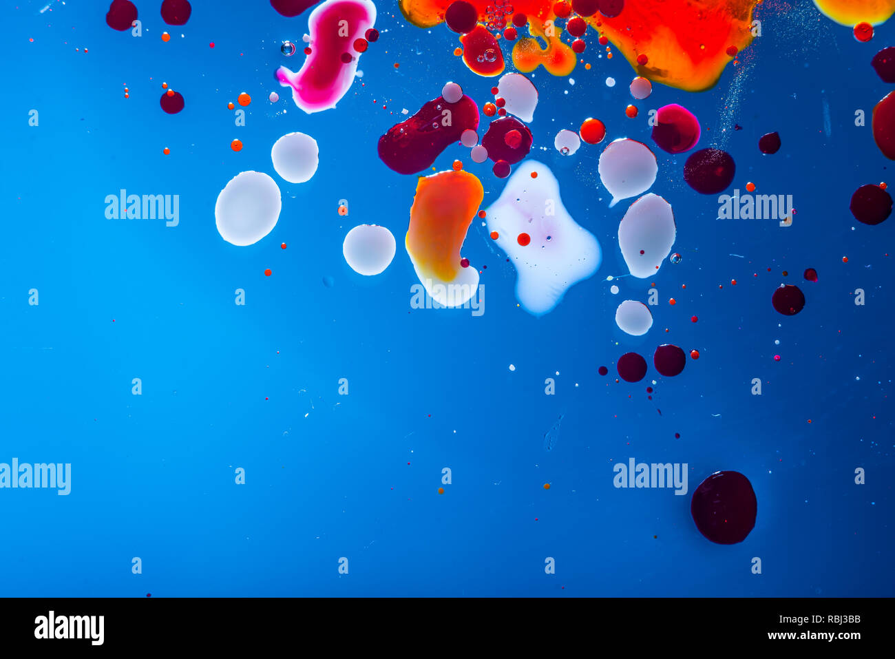 Red bubbles of blood cells on a blue background closeup. Abstraction of ...