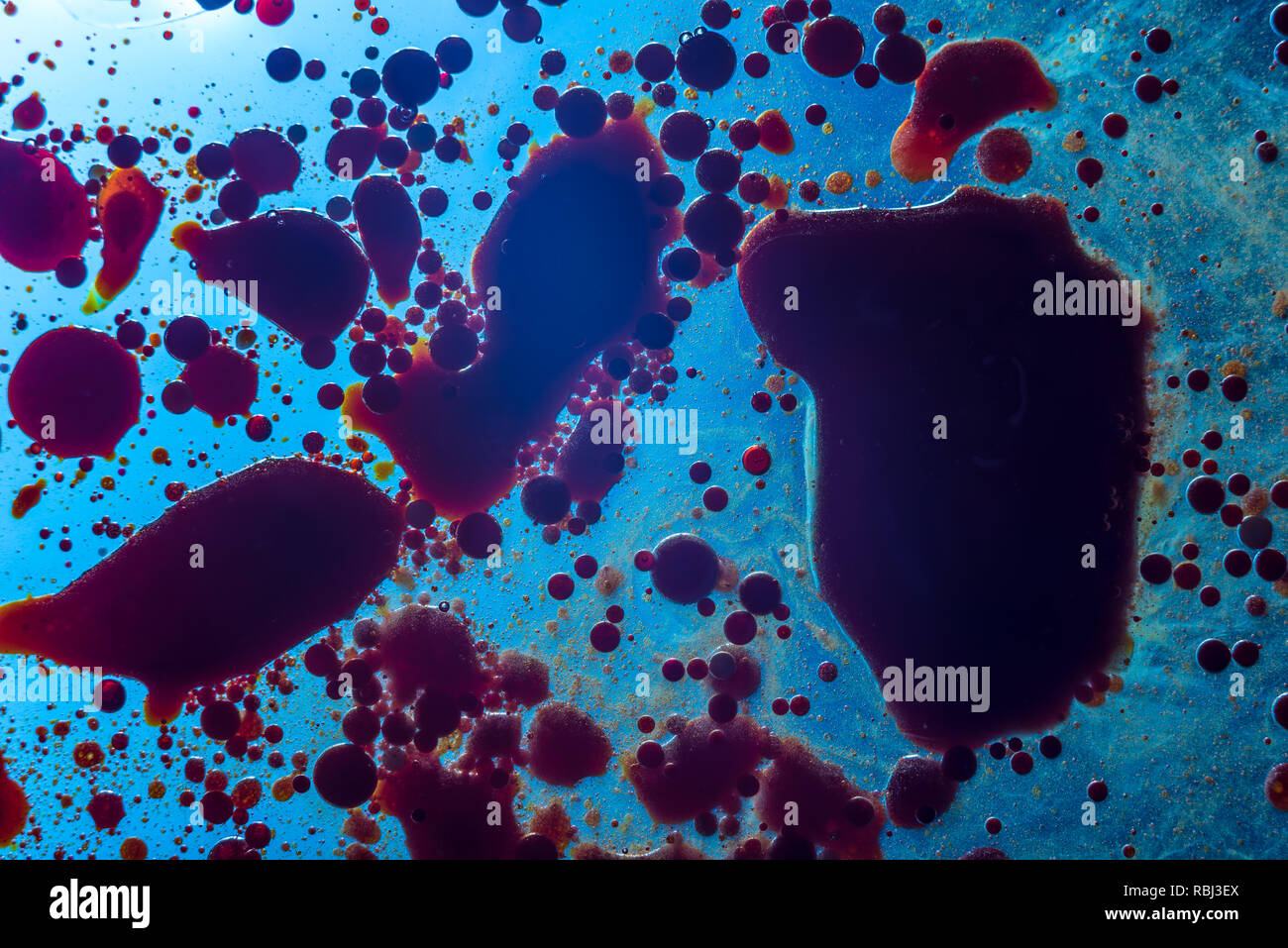 Red bubbles of blood cells on a blue background closeup. Abstraction of ...
