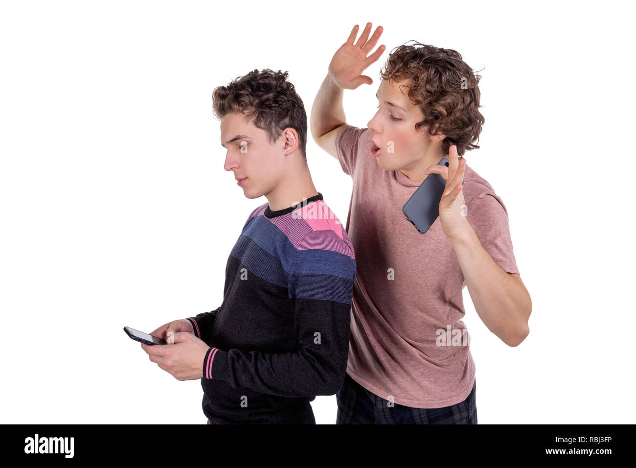 Portrait of a two happy young men using mobile phones Stock Photo - Alamy
