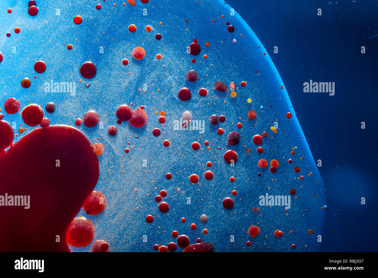 Red bubbles of blood cells on a blue background closeup. Abstraction of ...