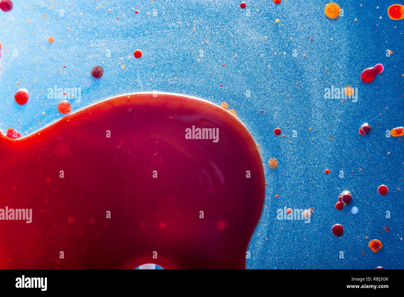 Red bubbles of blood cells on a blue background closeup. Abstraction of ...